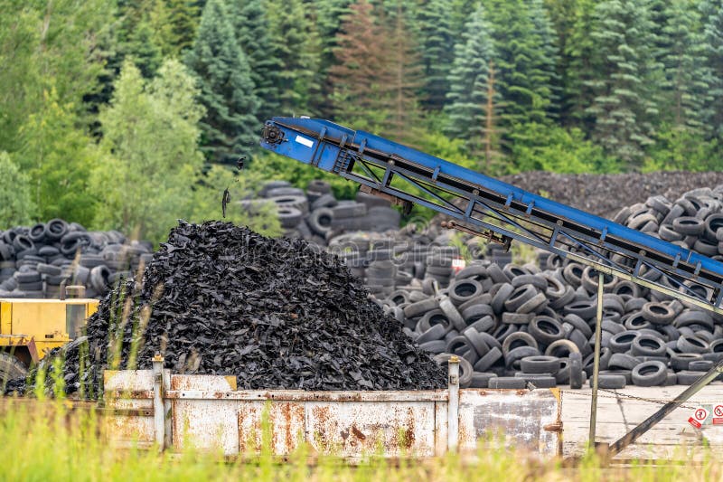 Recycling and Processing of Old Tires, Crushed Rubber Go on a Conveyor ...