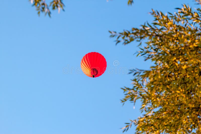 Red air-balloon over trees stock photo. Image of basket - 66735864