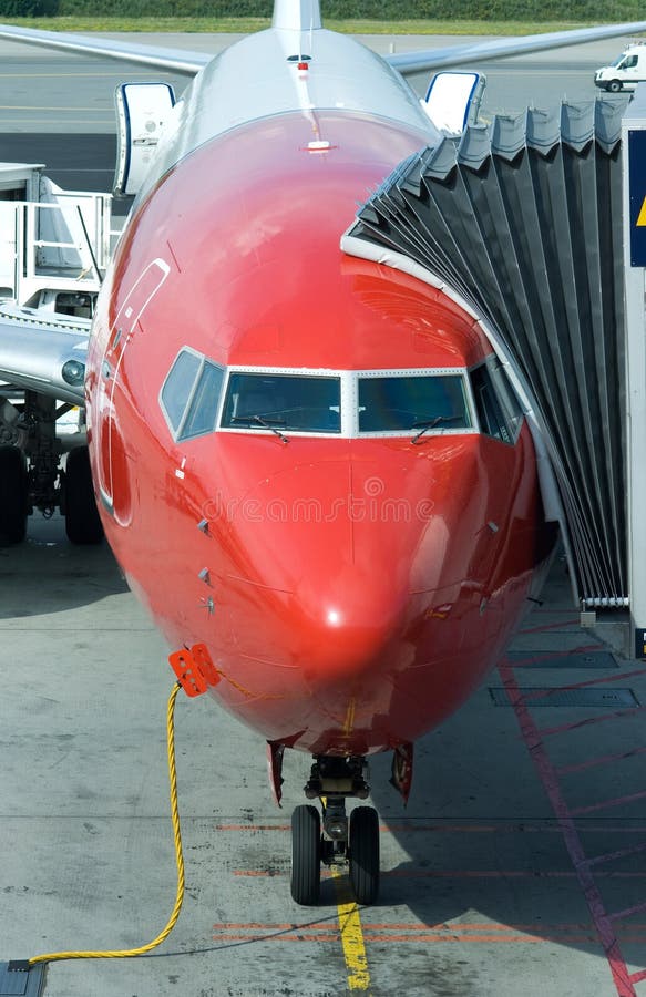Red airplane at the gate stock image. Image of boarding - 8119453