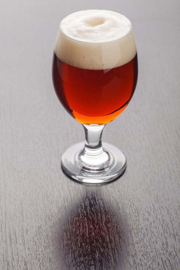 Red ale on dark table stock photo. Image of thirst, glass - 93143220