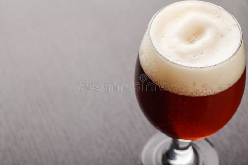 Red ale on dark table stock image. Image of alcohol, table - 93143337