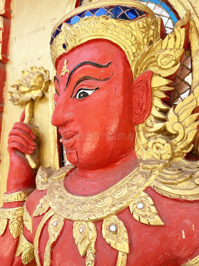 Red Angle Statue on Golden Wall Stock Photo - Image of culture, statue ...
