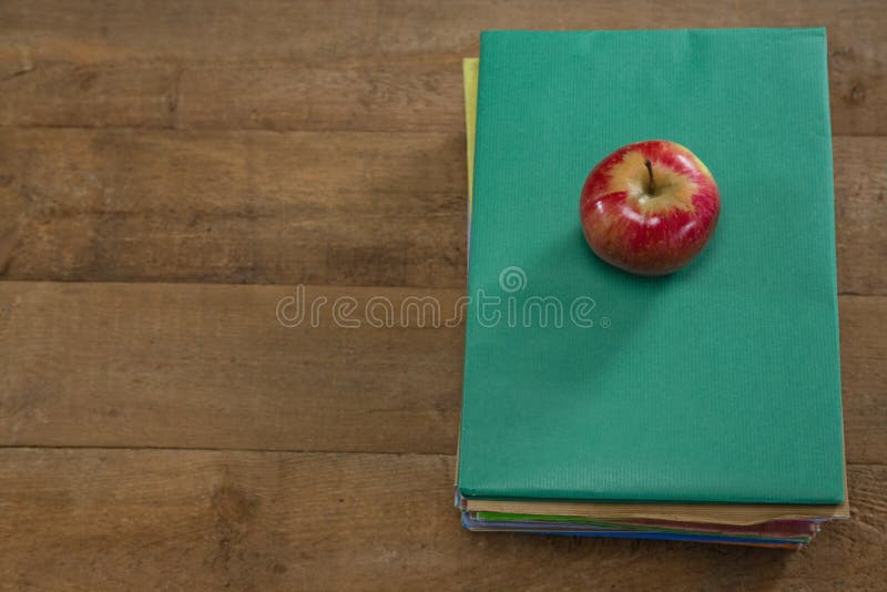 Red apple on book stack stock image. Image of freshness - 96364949