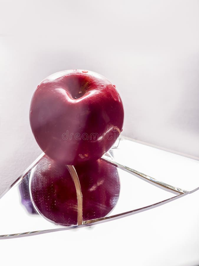Red apple on broken mirror stock image. Image of fruit - 83409615