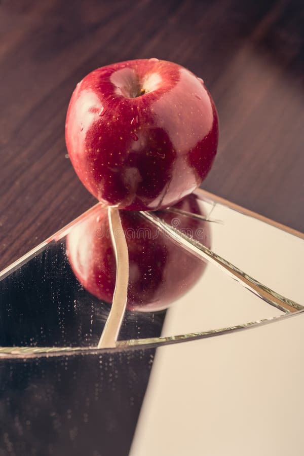 Red apple on broken mirror stock photo. Image of shattered - 83409702