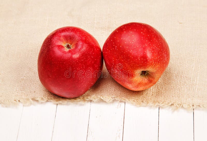 Red Apple on the Burlap and White Table Stock Image - Image of ...