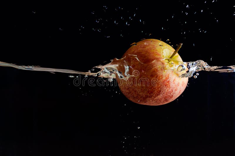 Red Apple Floating on the Water Isolated on Black Background Stock ...