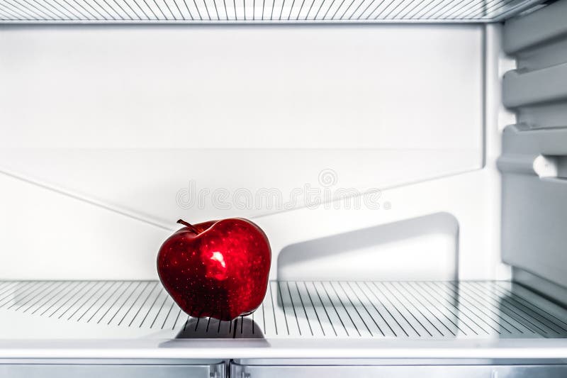 Red Apple Lying on the Empty Shelf of the Fridge. Colours Toned. Diet ...
