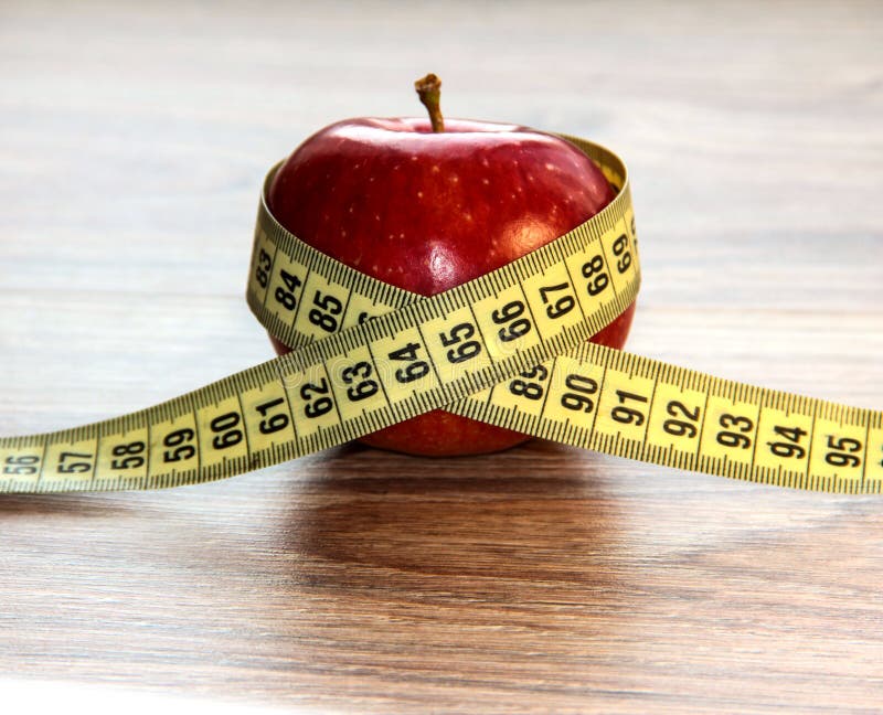 A Red Apple is Measured by a Meter. Slimness and Diet Stock Photo ...