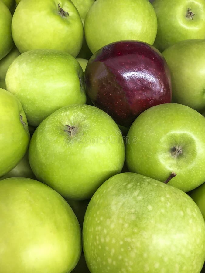 Red Apple in the Middle of Green Apples Stock Photo - Image of group ...