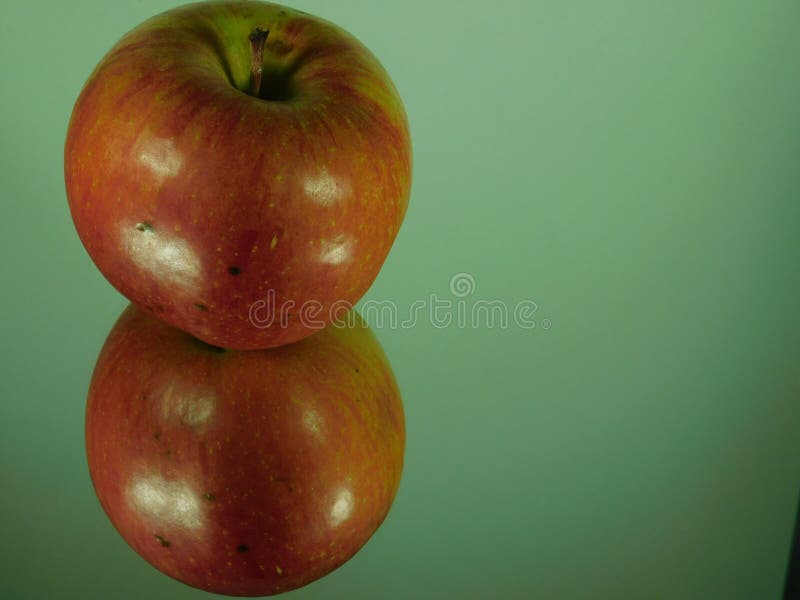 Apple in the mirror image stock photo. Image of brainchild - 36692732