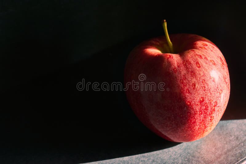 Red Apple with Natural Window Light, Creating Shadow and Black ...