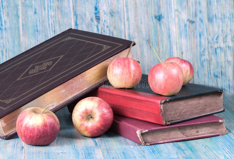 Red apple on old book stock image. Image of worn, cover - 62869647