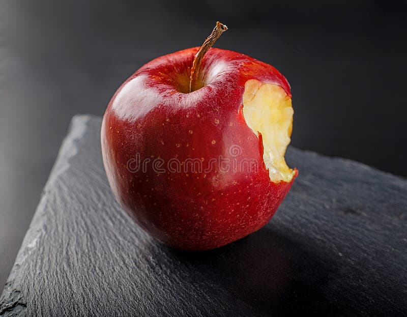 A Red Apple with a Single Bite Taken Out of it, Placed on a Slate ...
