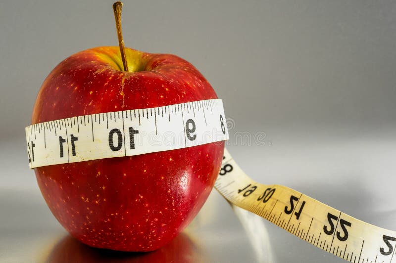 A Red Apple Sits on Top of a Tape Measure Stock Photo - Image of loss ...