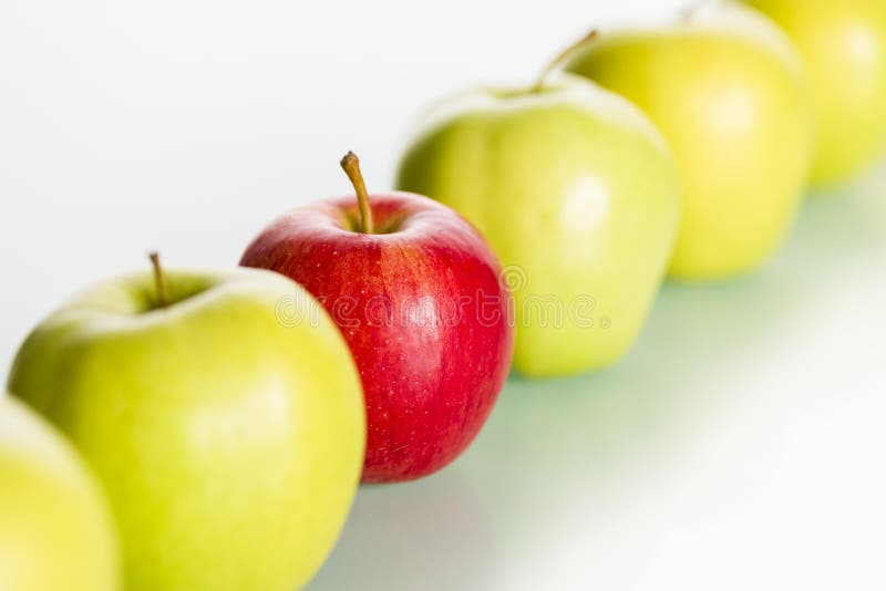 Red Apple Standing Out from Row of Green Apples. Stock Image - Image of ...
