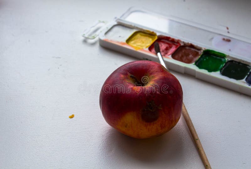 A Red Apple and Watercolor Paint and Brush on White Background Stock ...