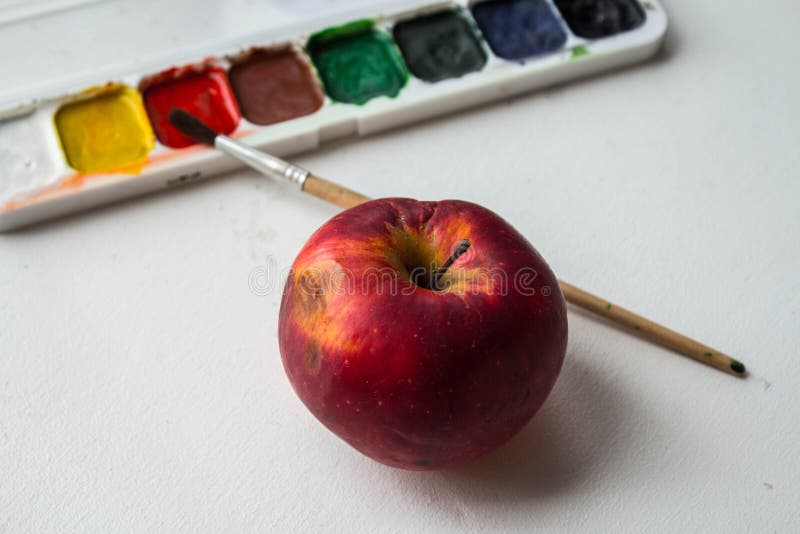 A Red Apple and Watercolor Paint and Brush on White Background Stock ...