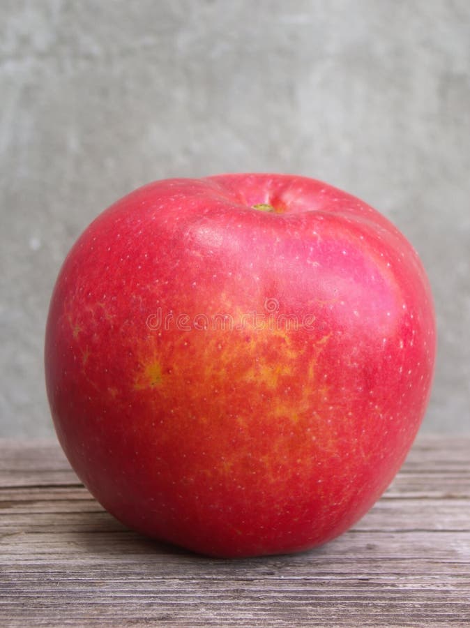Red apple on wooden table stock photo. Image of bright - 33404408