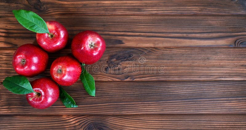 Red Apples with Leaves on Wooden Surface. a Top-down View of Five Shiny ...