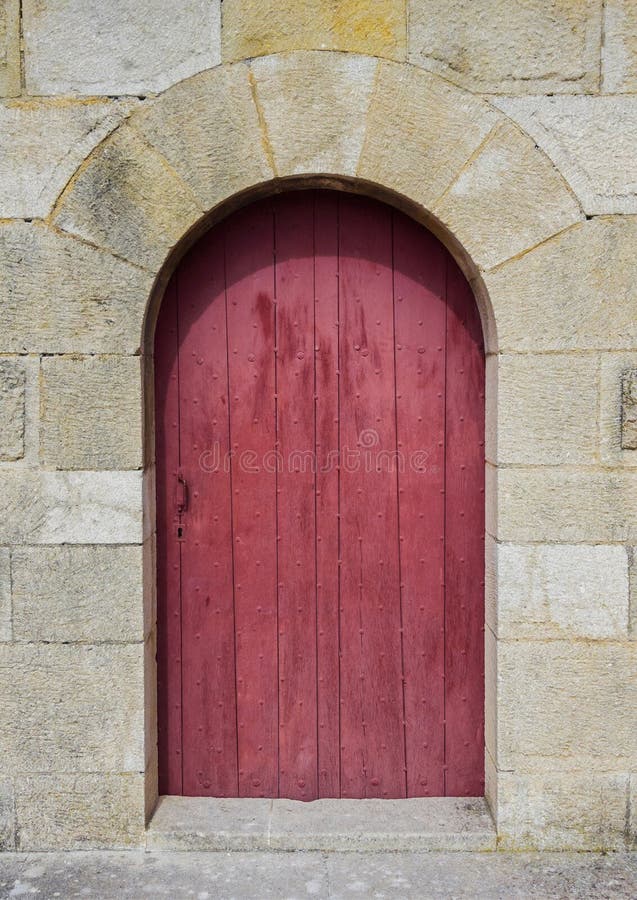 Red Arched Wooden Door in Stone Wall Stock Image - Image of aged ...