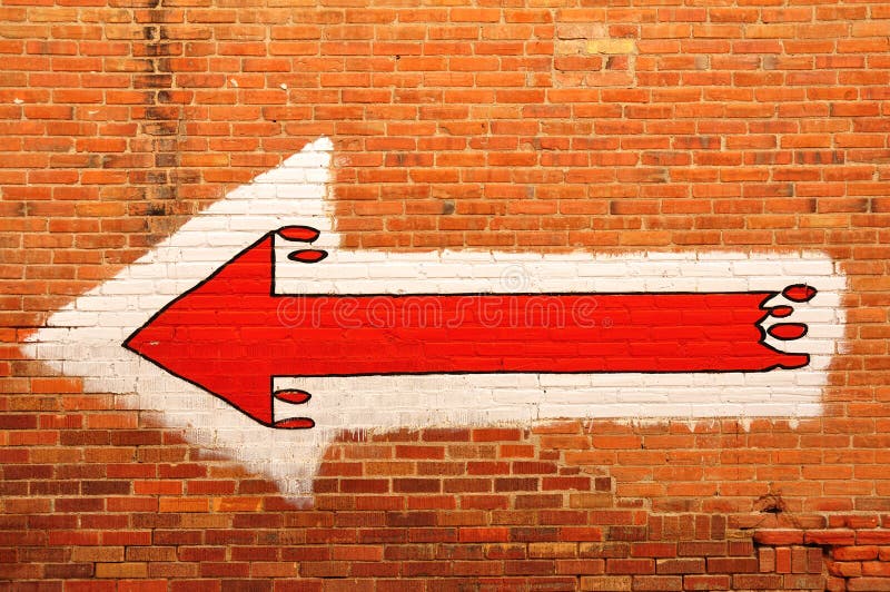 An arrow on a brick wall stock photo. Image of street - 19914454