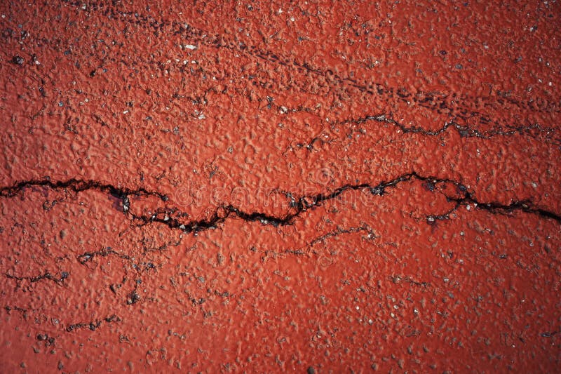 A crack in the red asphalt stock image. Image of outdoor - 380282875