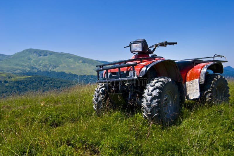 Red atv on highlands- quad stock image. Image of terrain - 6511505
