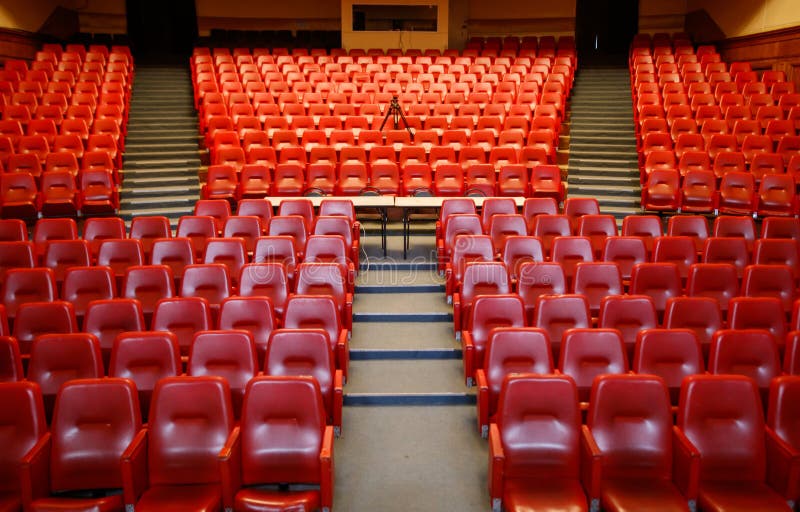 A Red Auditorium with Rows of Chairs and a Stage Stock Photo - Image of ...