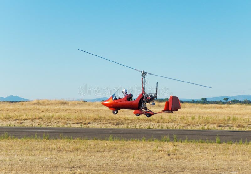 Red autogiro taking off stock image. Image of gear, speed - 34575273