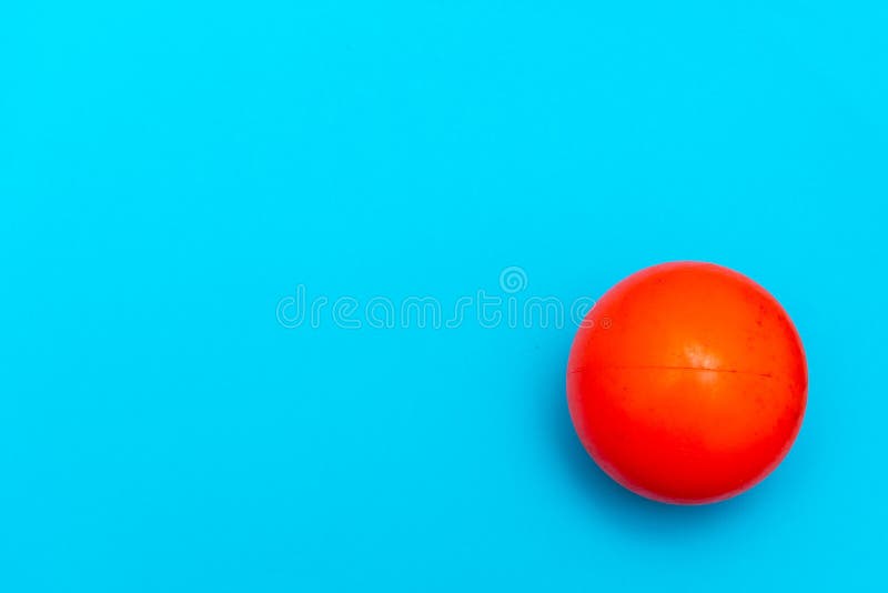 Red Ball Hockey Ball on a Solid Bright Blue Flat Lay Background ...