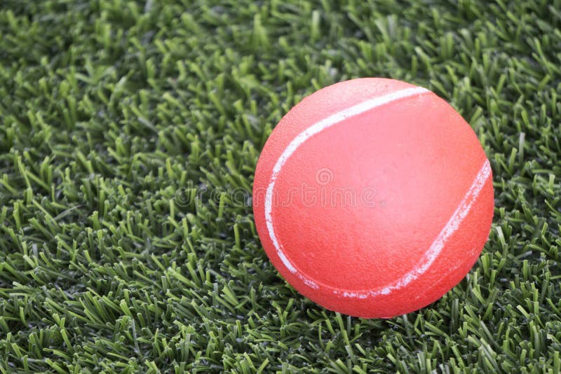 Red ball on green grass stock photo. Image of green - 120060620