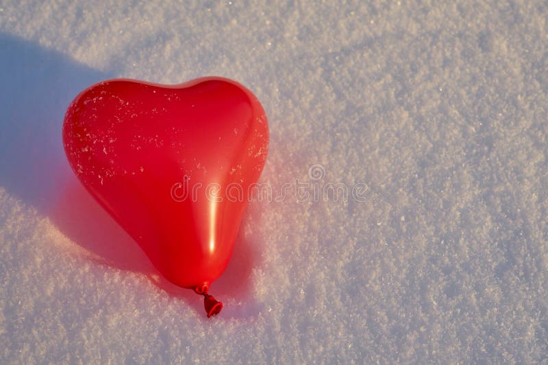 A Red Ball in the Shape of a Heart in the Snow Stock Photo - Image of ...