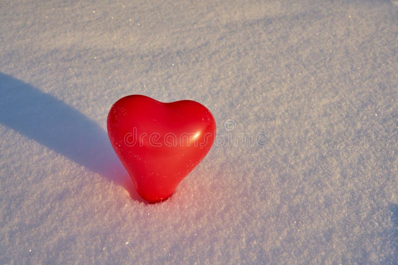 A Red Ball in the Shape of a Heart in the Snow Stock Photo - Image of ...