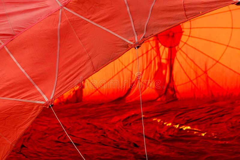 A Red Balloon is Being Inflated and the Inside of the Balloon is Red ...