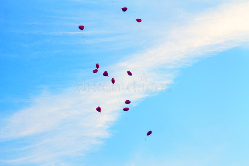 Red Balls in the Form of a Heart Fly into the Blue Sky. Stock Photo ...