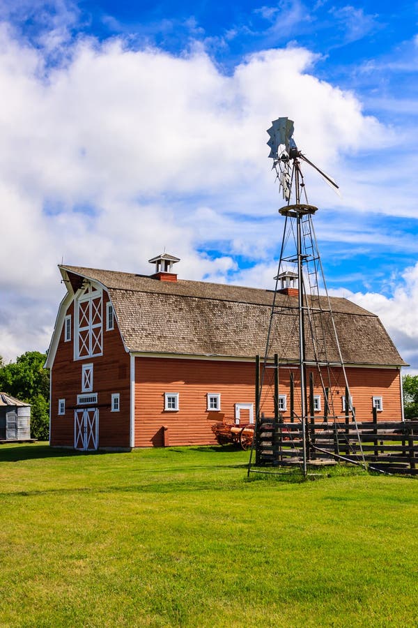 A Red Barn with a Windmill on Top Stock Photo - Image of construction ...