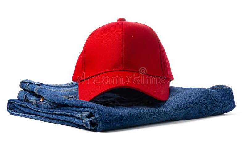 Red Baseball Cap Resting Atop Folded Blue Denim Jeans Against a White ...