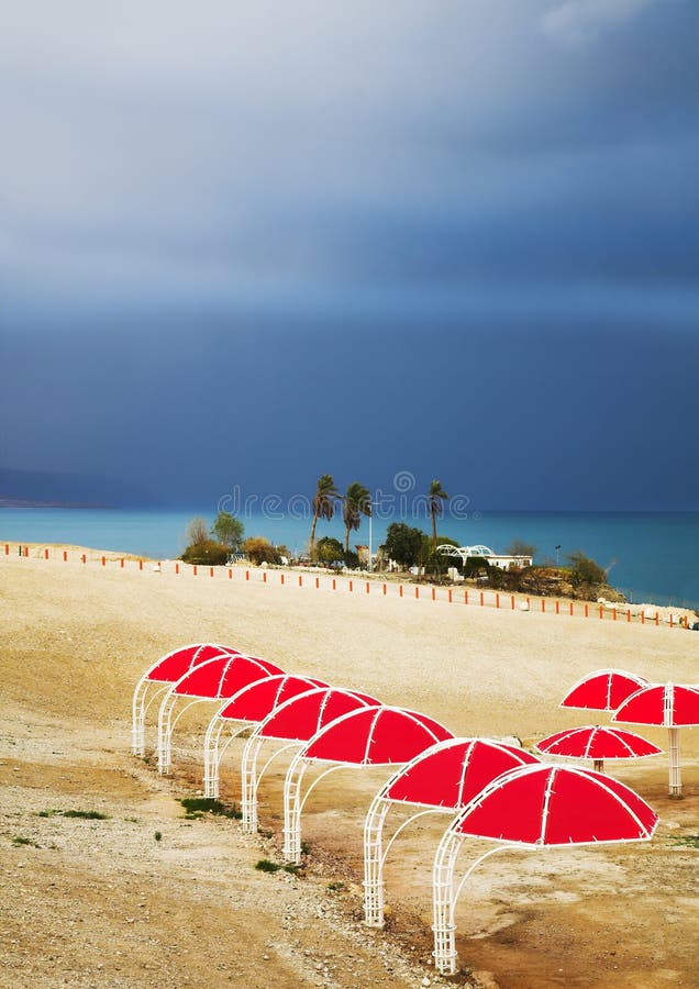 Red Beach Umbrellas on Coast of the Dead Sea in Thunder-storm Stock ...