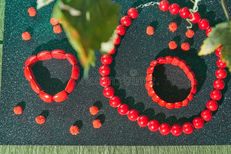 Red Beads Lying on an Unusual Surface and a Red Bracelet Stock Image ...