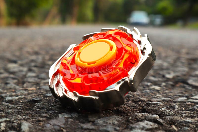 Red Beyblade is on the Asphalt Stock Photo - Image of ashphalt, light ...