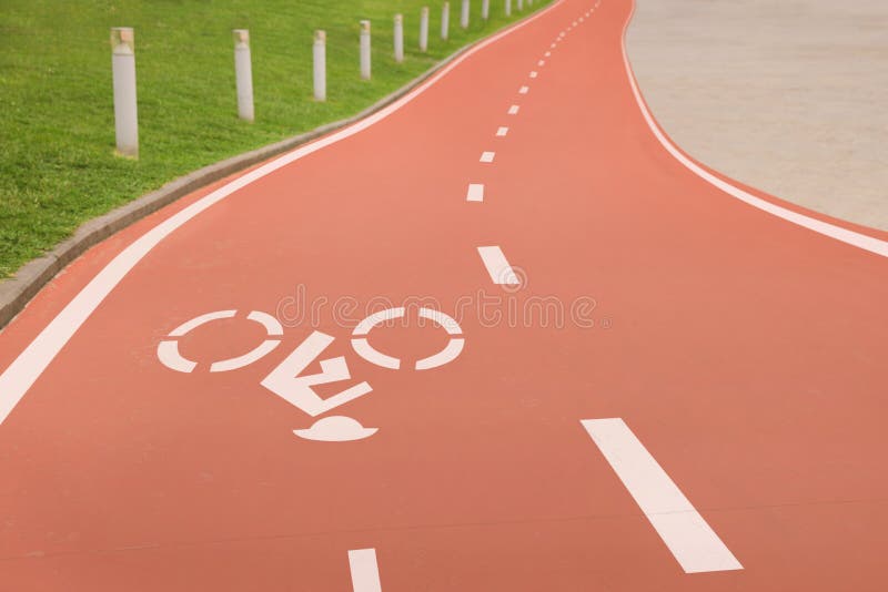 Red Bike Lane with Painted White Bicycle Sign Stock Image - Image of ...