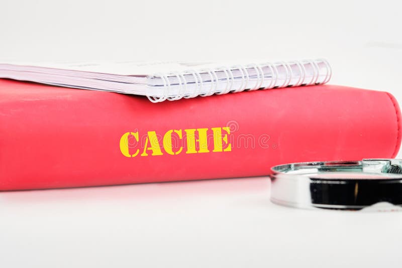 A Red Binder Prominently Labeled Cache Rests on a Flat Surface Next To ...