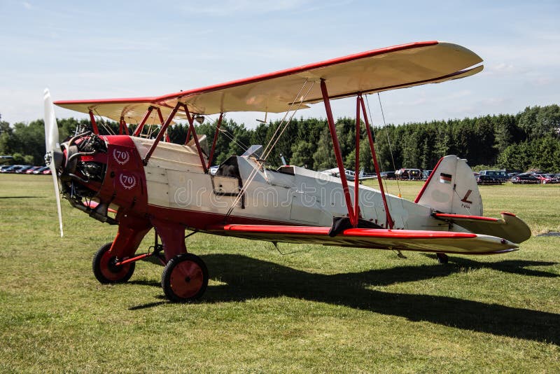 Red Biplane Airplane on Meadow Editorial Stock Photo - Image of field ...
