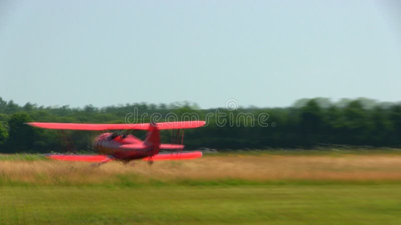 Red biplane takeoff stock footage. Video of grass, airplane - 347035256