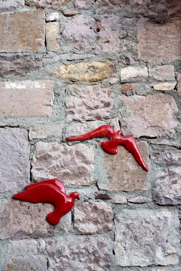 Red birds on stone wall stock photo. Image of summer - 49848830