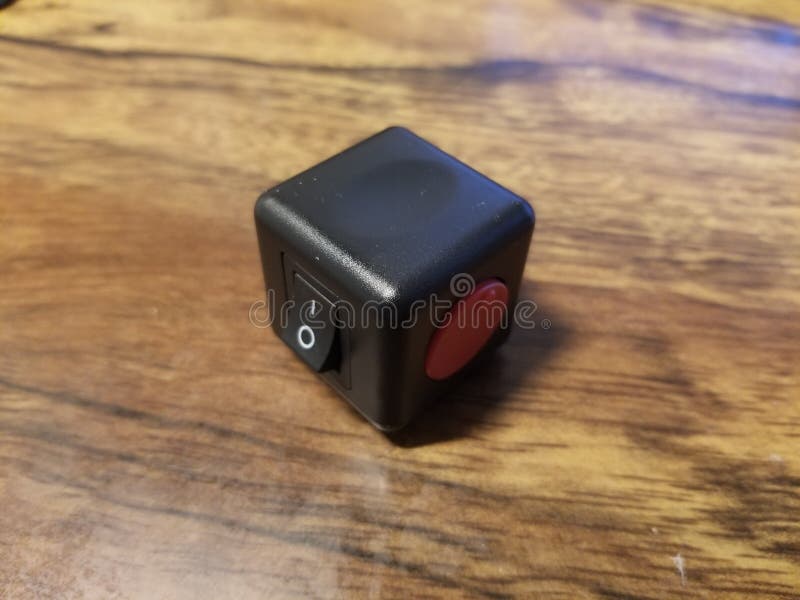 Red and Black Fidget Cube Sitting on a Table Stock Photo - Image of ...