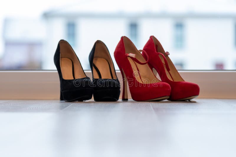 Red and Black High Heel Pumps in Front of a Window and on a Light Floor ...