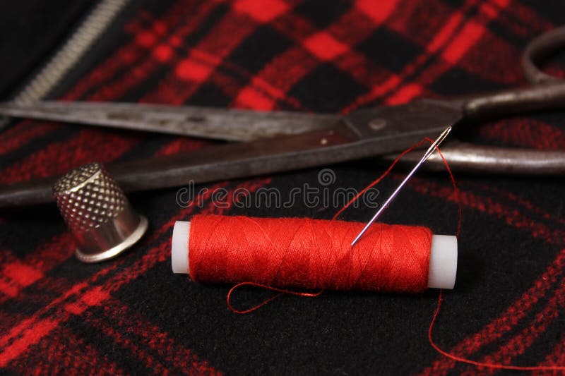 Red and Black Plaid Fabric with Thread and Scissors Stock Image - Image ...