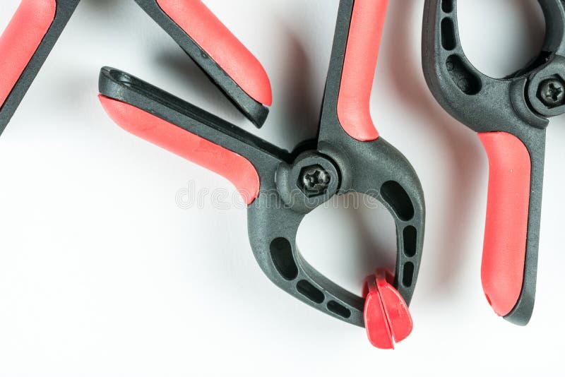 Red and Black Plastic Carpenters Pinch Tools Flat Lay Above White ...